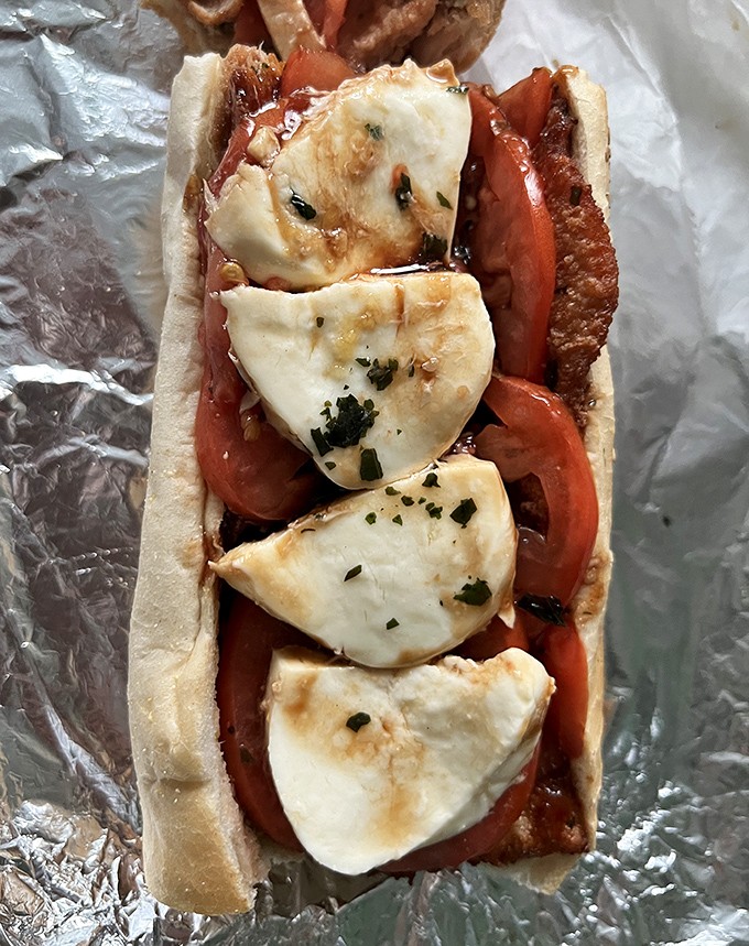 Fresh mozzarella, ripe tomatoes, and what appears to be prosciutto&mdash;the Italian heritage of South Philly captured between two pieces of bread.