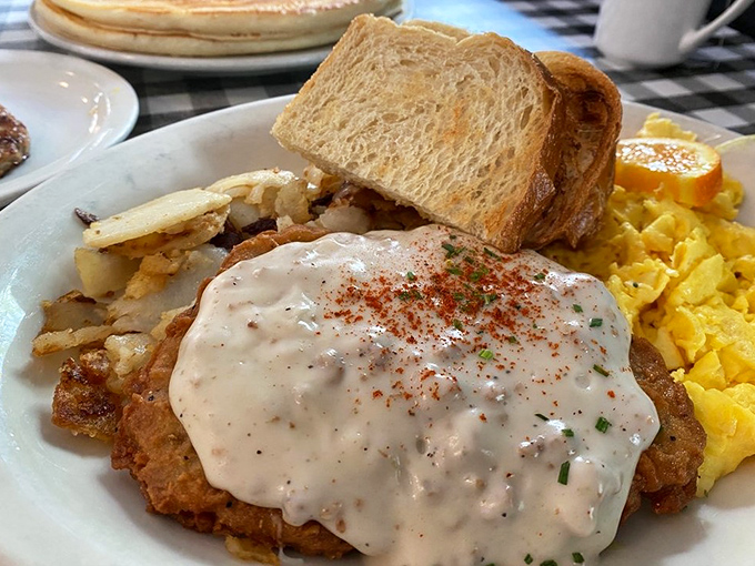 Comfort food architecture at its finest&mdash;a foundation of crispy chicken, crowned with creamy gravy and sprinkled with just enough spice.