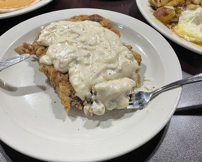 Behold the crown jewel of comfort food: chicken fried steak swimming in peppery gravy. Diet plans come here to die glorious, delicious deaths.