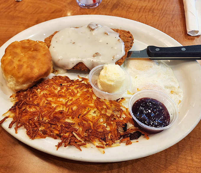 Country fried steak smothered in gravy that would make your grandmother both proud and jealous, with hash browns that achieved the perfect crisp-to-tender ratio.