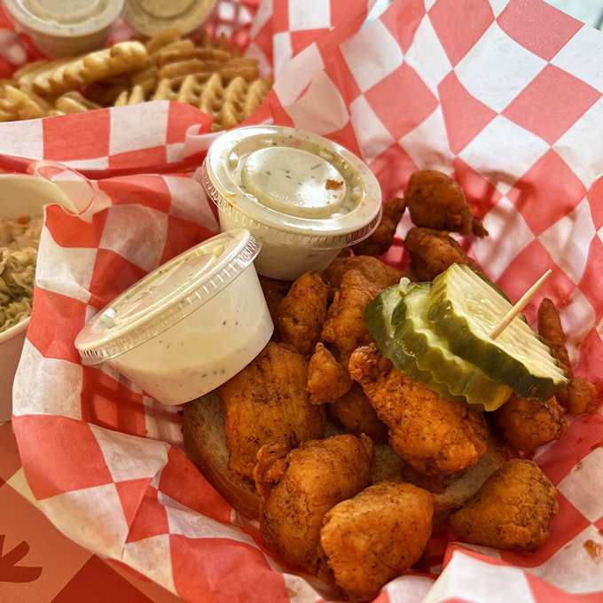 These nuggets of joy rest on traditional white bread, accompanied by house-made pickles and dipping sauces. Napkins required, no judgment passed.