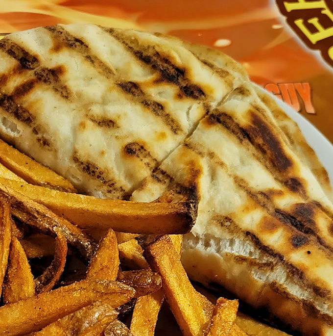Perfectly grilled flatbread cradles melted cheese and chicken in a warm embrace. The grill marks aren't just decoration&mdash;they're flavor tattoos.