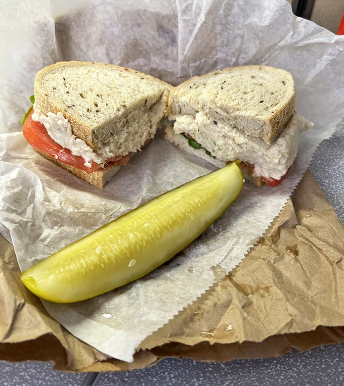 The legendary chicken salad sandwich arrives with its faithful sidekick&mdash;a pickle spear that cuts through richness like a tart, crunchy superhero.