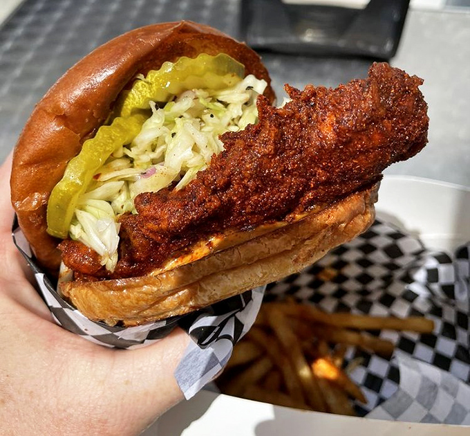 
The sandwich that launched a thousand road trips: perfectly fried chicken, vibrant slaw, and pickles on a soft bun&mdash;architecture that deserves its own blueprint. 