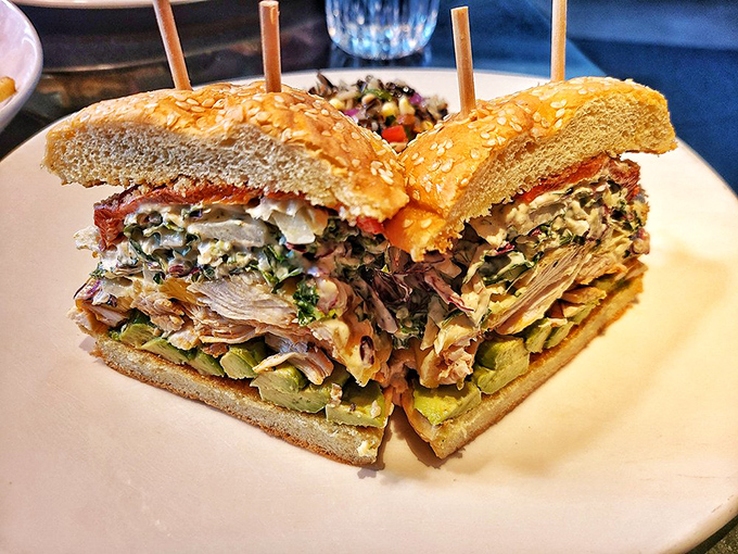 This isn't just a sandwich; it's an architectural marvel of flavors. Skewers hold together what might otherwise collapse under its own deliciousness.