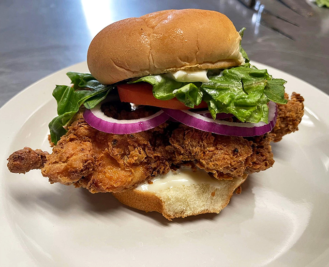 This towering chicken sandwich proves that sometimes the best things in life require both hands and zero shame.