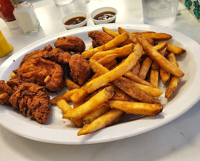 
Golden-brown chicken tenders that shatter with each bite, paired with fries that could make a Frenchman weep with joy.