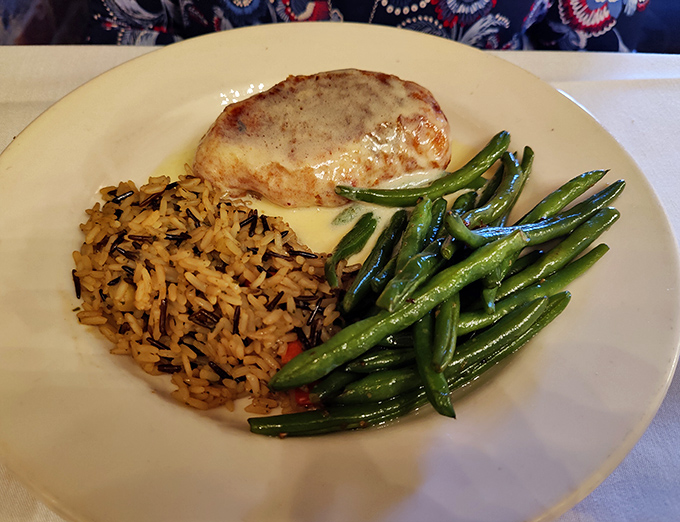 Chicken Wellington elevated to an art form, accompanied by wild rice and crisp green beans.