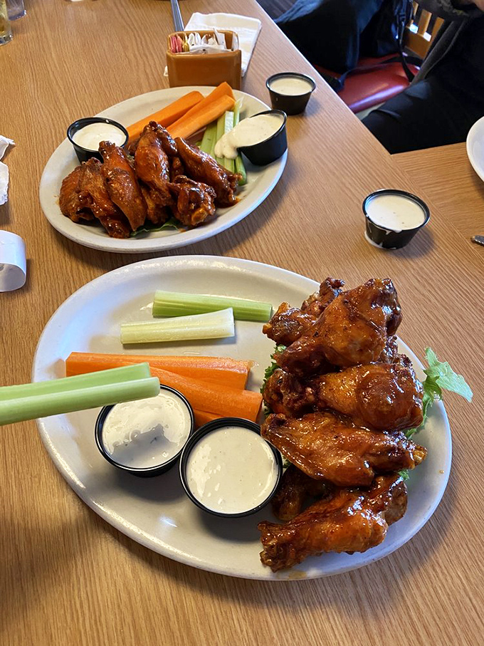 Buffalo wings that don't mess around, served with the holy trinity of accompaniments: crisp veggies, cooling dip, and absolutely zero pretension.