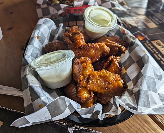 Wings that don't need a sports game excuse to be devoured—smoky, saucy, and served with dipping options that make choosing harder than picking lottery numbers.