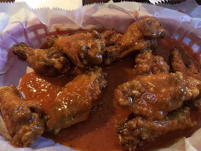 These wings aren't just cooked, they're transformed. Glistening with sauce and promising the kind of flavor that makes grown adults lick their fingers in public.