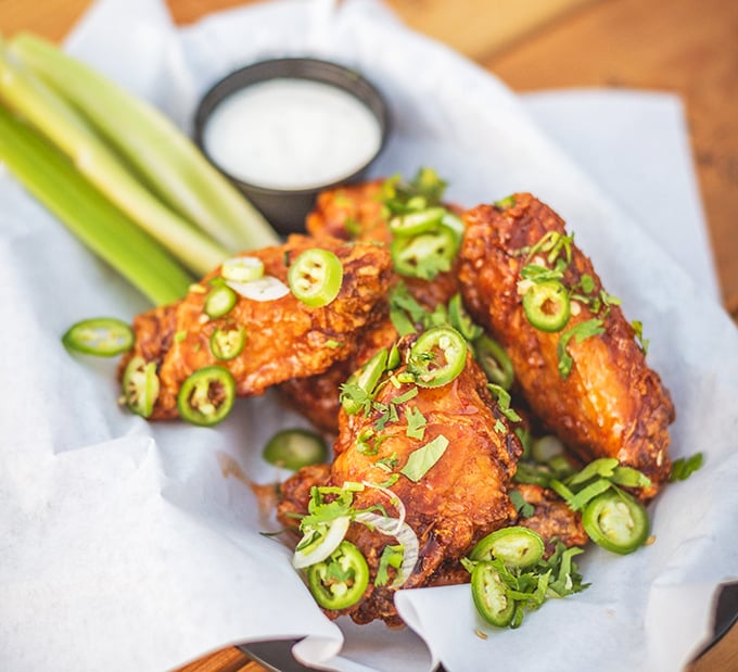 These aren't just wings; they're flavor delivery vehicles garnished with jalape&ntilde;os for those who believe heat is not just a temperature but a lifestyle choice.