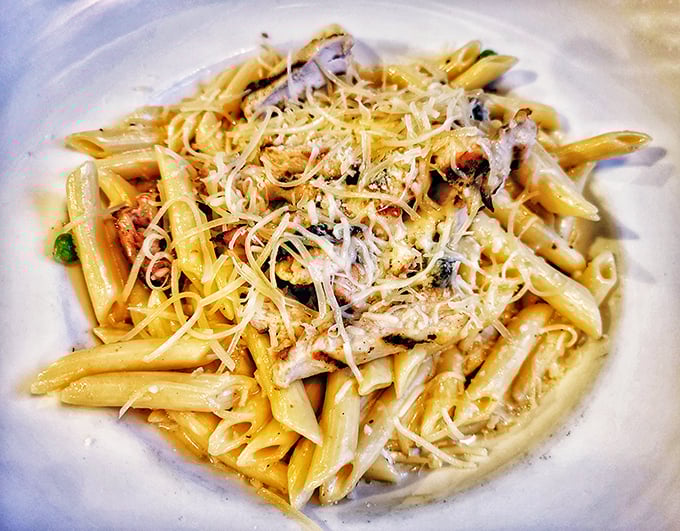 Pasta perfection that would make an Italian grandmother nod in approval. The penne carbonara glistens with creamy sauce and promises comfort in every bite.