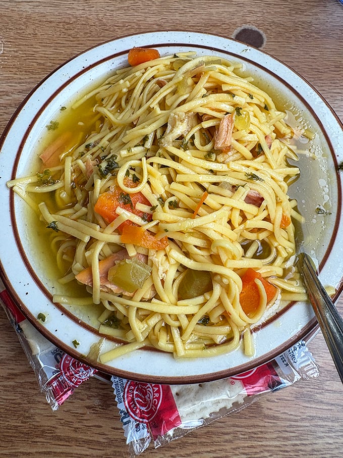 The legendary chicken noodle soup, where perfectly al dente noodles swim alongside tender chicken in a broth clear enough to see your future in.