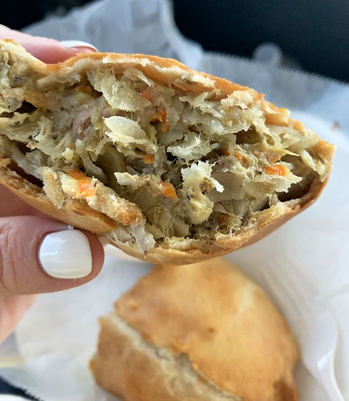 A cross-section reveals the magic within: perfectly diced vegetables and meat, neither too chunky nor too fine, creating that signature texture that keeps fans coming back.