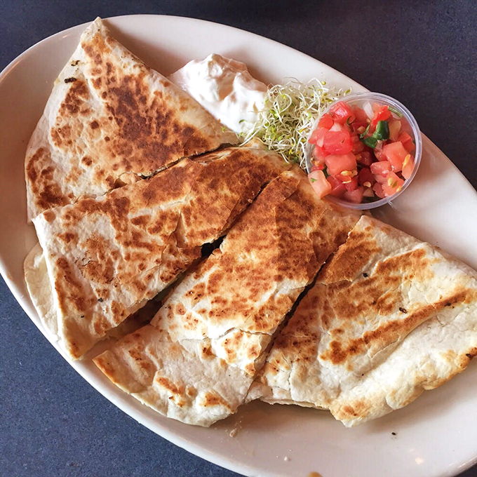 This quesadilla isn't just grilled—it's transformed into a crispy, cheese-oozing masterpiece that makes you wonder why you'd order anything else.