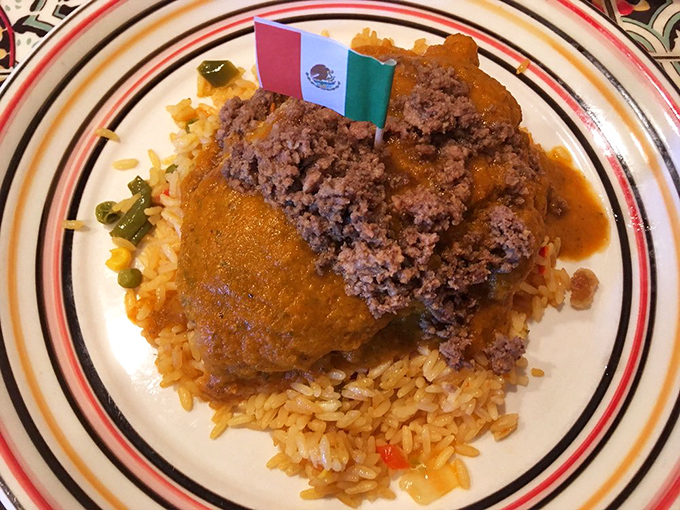 That's not just a chile relleno&mdash;it's a Mexican flag-topped masterpiece resting on a bed of rice that clearly didn't come from a box with instructions.