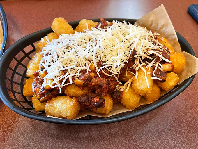 Tater tots get the royal treatment with chili and cheese &ndash; comfort food royalty in basket form.