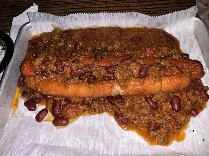 Not your average chili dog. This beast comes buried under a mountain of hearty beef chili and beans&mdash;fork required, napkins essential.
