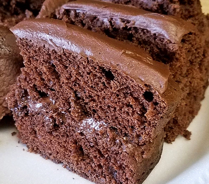 Chocolate cake so moist and rich it makes you wonder why anyone bothers with trendy desserts when perfection was already invented decades ago.