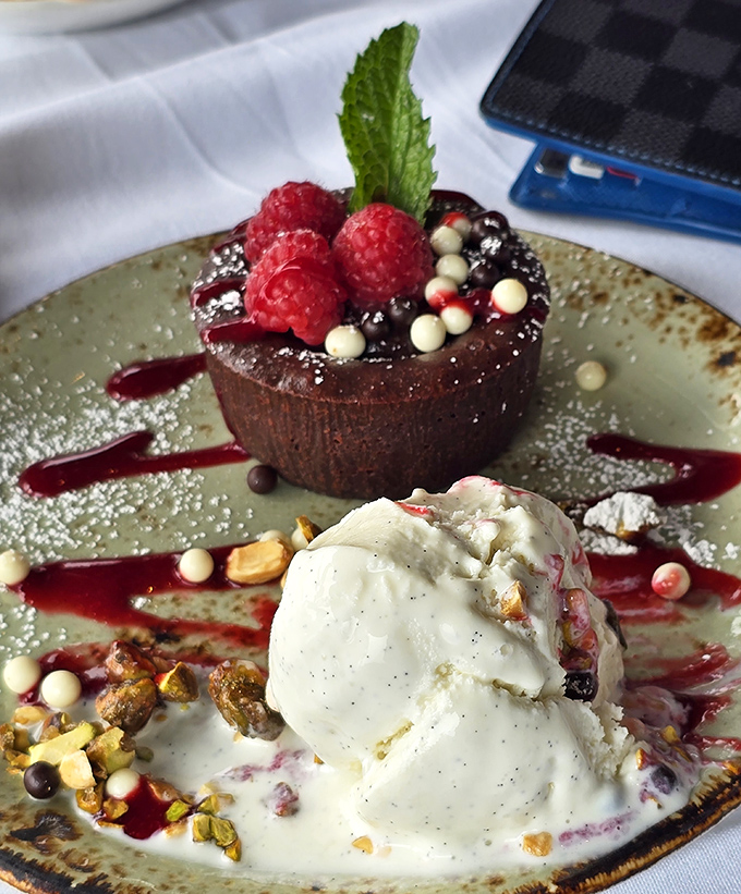 This chocolate truffle cake with berry garnish proves that even seafood restaurants can nail the sweet finale flawlessly.