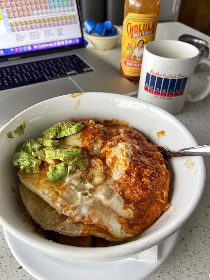 When breakfast gets saucy! Melted cheese blankets this hearty bowl topped with fresh avocado&mdash;proof that sometimes messy equals magnificent.