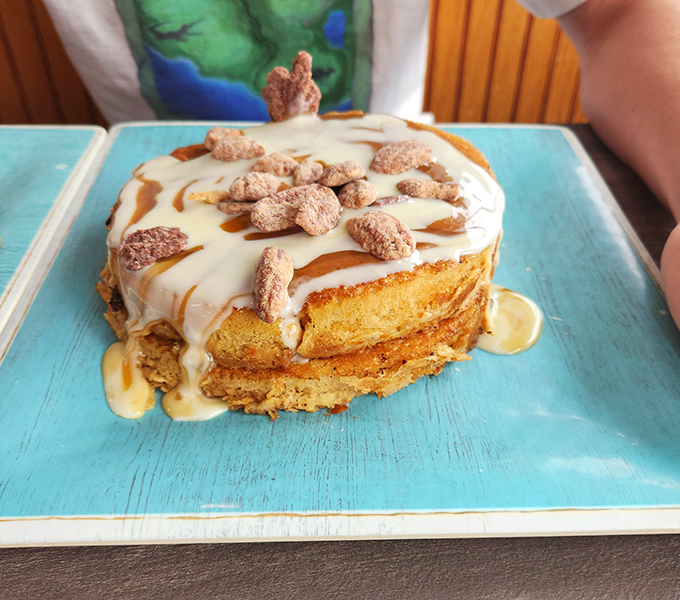 The Peanut Butter Delight pancakes arrive like a tower of breakfast indulgence, drizzled with enough sweetness to make your dentist wince and your heart sing.