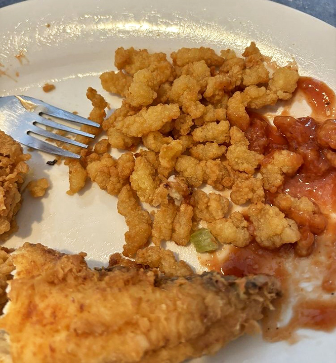 These delicate clam strips aren't just fried—they're transformed into crispy ocean morsels that disappear faster than beach parking on July 4th.