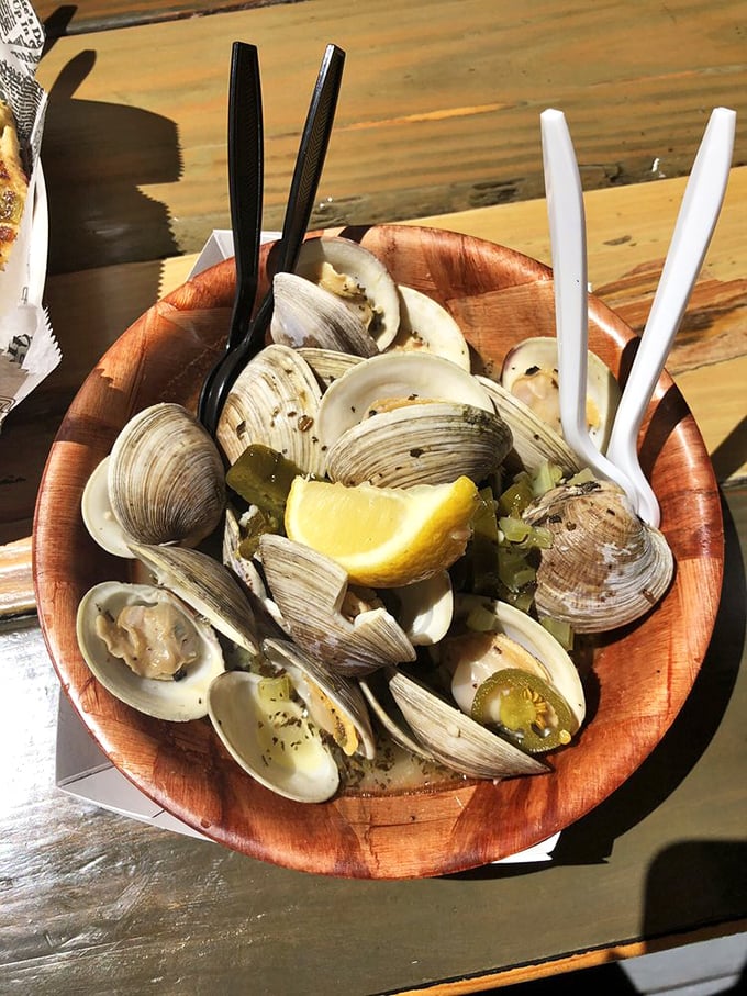 These steamed clams, glistening in their wooden bowl with a hint of lemon, are what seafood dreams are made of.