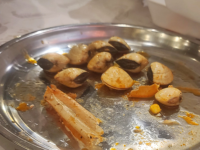 These clams have clearly been somewhere interesting before landing on your plate. Their story ends deliciously in a pool of garlicky sauce.