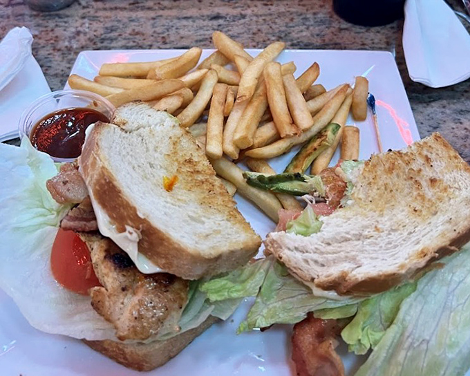 The legendary club sandwich in its natural habitat—triple-decker architecture that would make Frank Lloyd Wright weep with joy.