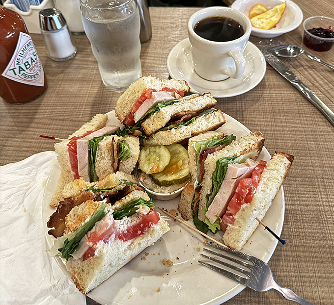 The club sandwich at Lou Mitchell's stands tall and proud, like a delicious skyscraper built by someone who understands the architecture of satisfaction. 