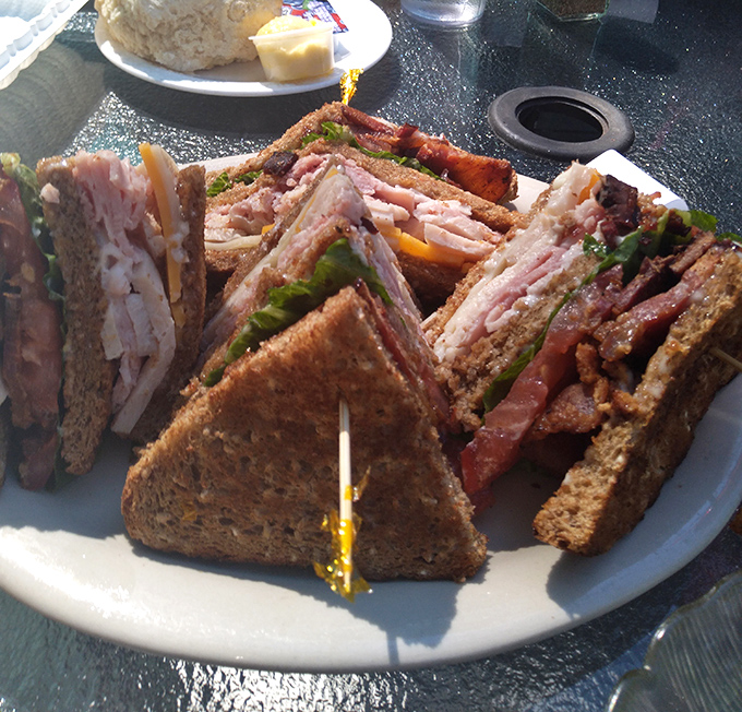 This club sandwich stands taller than most Oregon firs, layered with enough meat to make a carnivore weep with joy.