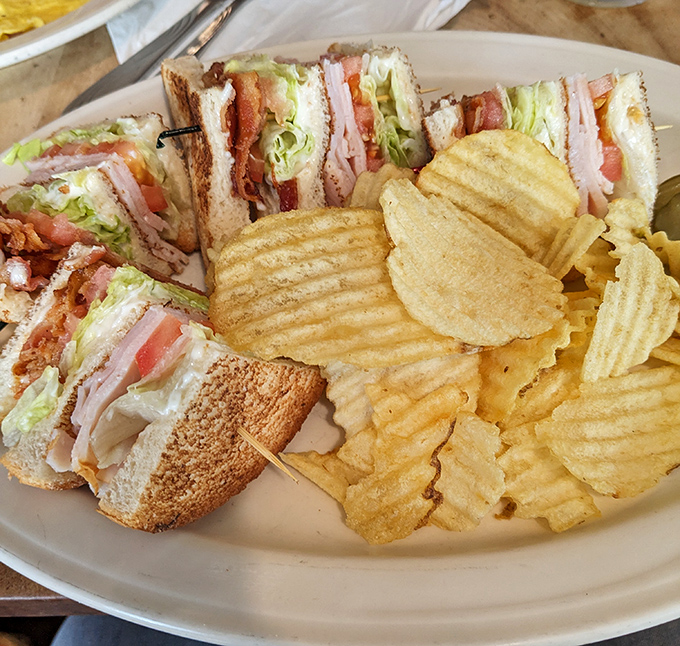 The club sandwich – architecture you can eat, where each layer tells its own delicious story of crispy bacon and fresh ingredients.