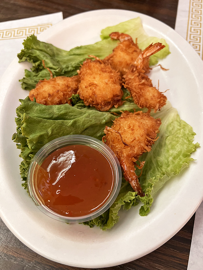 Golden coconut shrimp that crunch like autumn leaves, served with a sweet sauce that makes you consider drinking it straight.