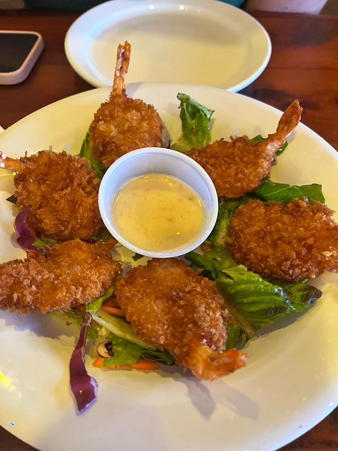 Golden coconut shrimp that crunch like ocean waves and taste like tropical vacation dreams come true.