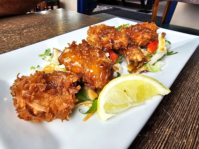 These coconut shrimp arrive like little golden treasures, each bite delivering tropical sweetness with oceanic satisfaction in perfect harmony.