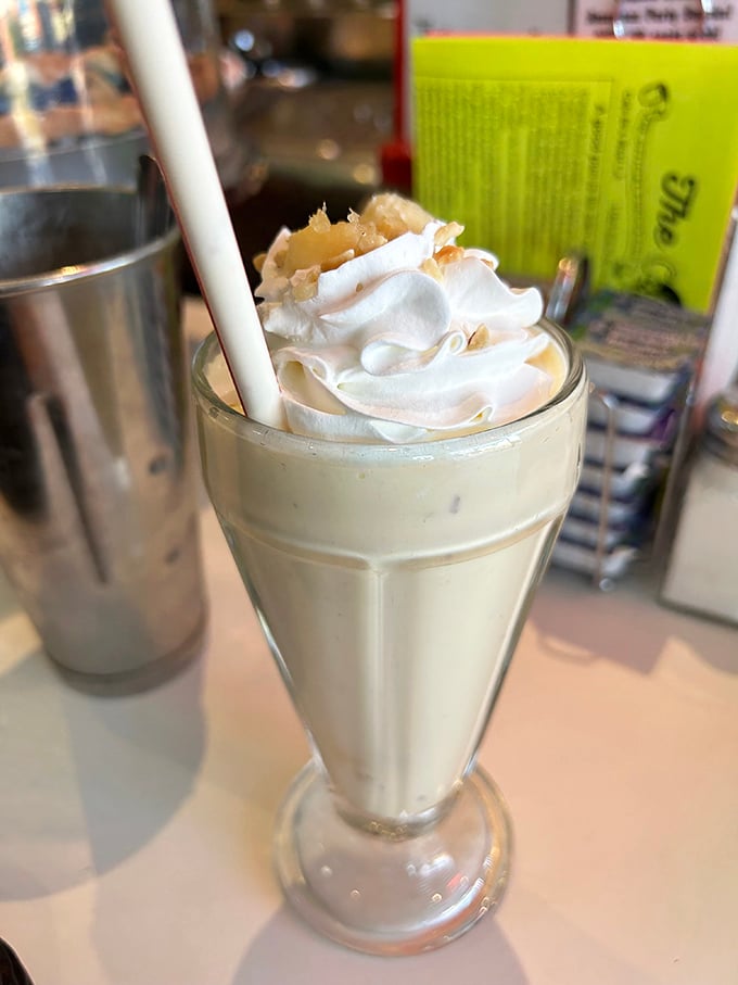 The vanilla shake arrives with its metal mixing cup sidekick, like Batman and Robin of the dessert world, ready to save you from boring beverages.