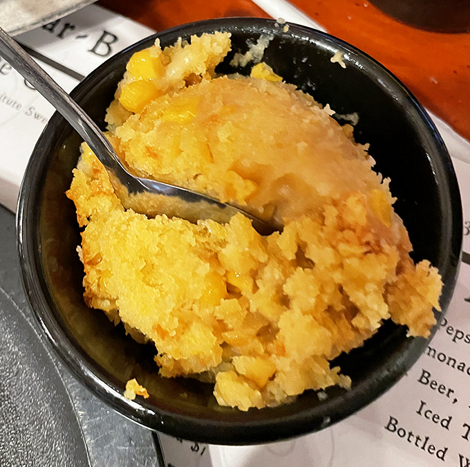 Cornbread soufflé that's somehow both fluffy and substantial—like eating a golden cloud that tastes like the South.