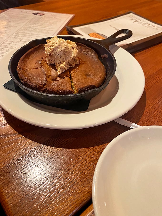 The cornbread arrives in its own cast iron skillet, a golden disc of buttery perfection that would make a Southerner weep with joy.