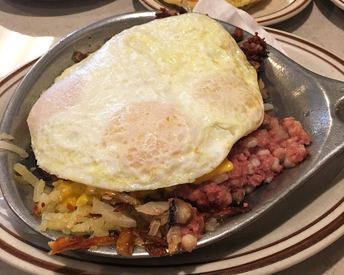 Behold the skillet that launched a thousand satisfied sighs—corned beef hash topped with a perfectly fried egg. The ultimate "I'm treating myself today" breakfast.