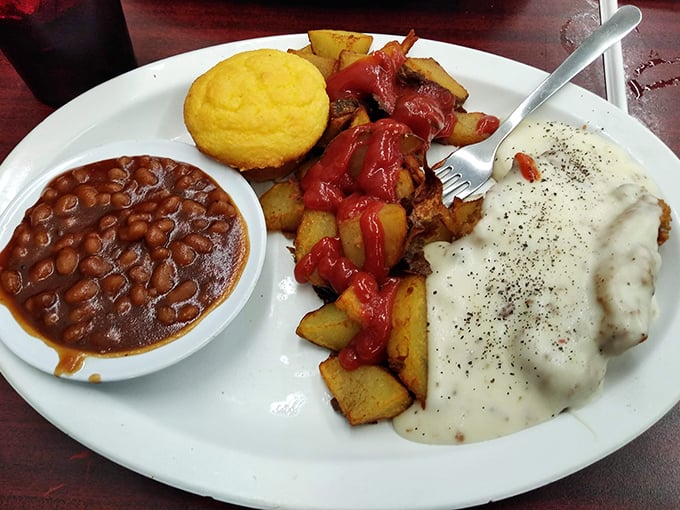 Country fried steak smothered in gravy with a cornbread sidekick. A plate that says, "Go ahead, cancel your dinner plans. You won't be hungry."