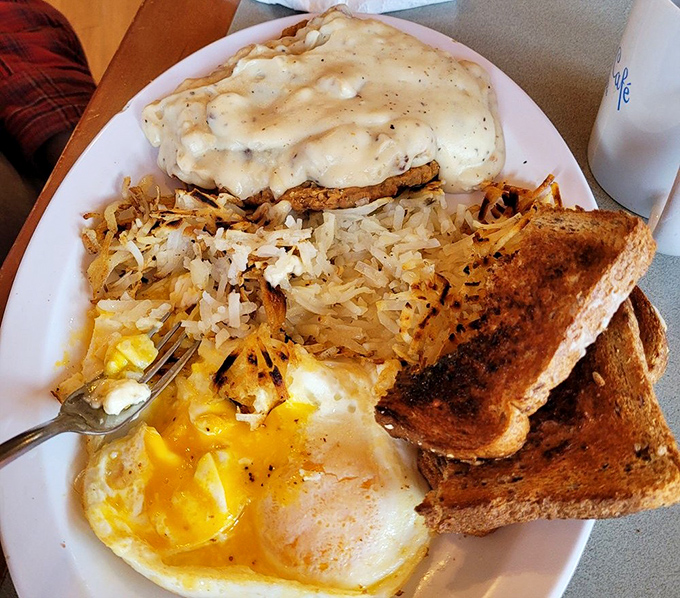 The star attraction: chicken fried steak smothered in country gravy alongside hash browns and eggs. Diet plans come here to die gloriously.