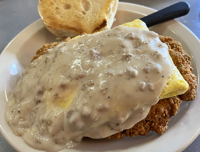 Country Fried Steak swimming in creamy gravy&mdash;where every bite requires a commitment but rewards you with pure comfort food bliss.