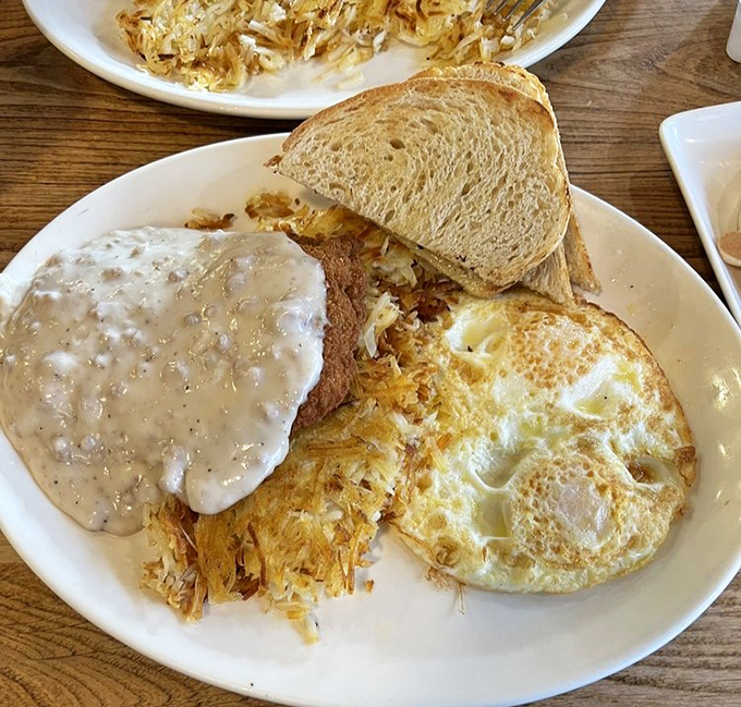 Country fried steak smothered in gravy alongside sunny-side-up eggs&mdash;comfort food that whispers, "Go ahead, take that nap later. You've earned it."
