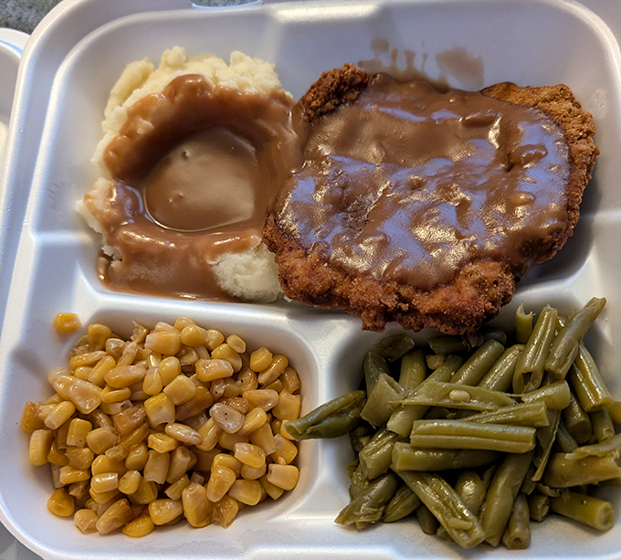 Southern comfort on a plate&mdash;country fried steak swimming in gravy alongside creamy corn and green beans. Grandma would approve, then ask for seconds.