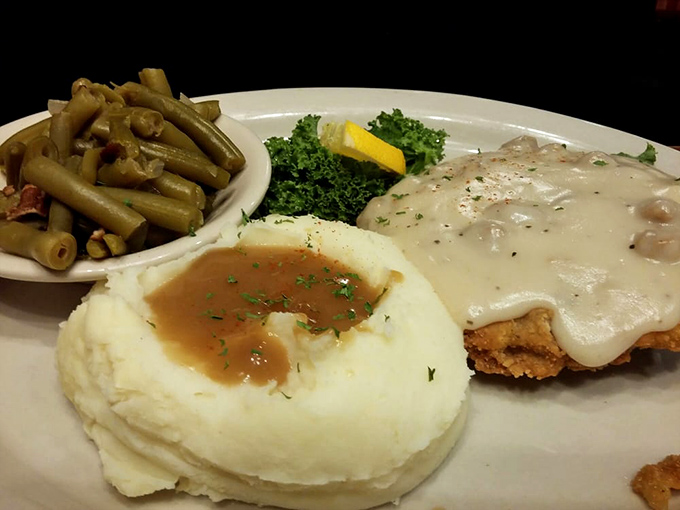 Country fried steak that's achieved the impossible trifecta: crispy coating, tender meat, and gravy that should be classified as a controlled substance.