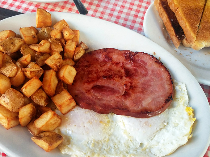 Breakfast of champions: country ham with that perfect pink hue, eggs sunny-side up, and home fries that could make a potato proud.