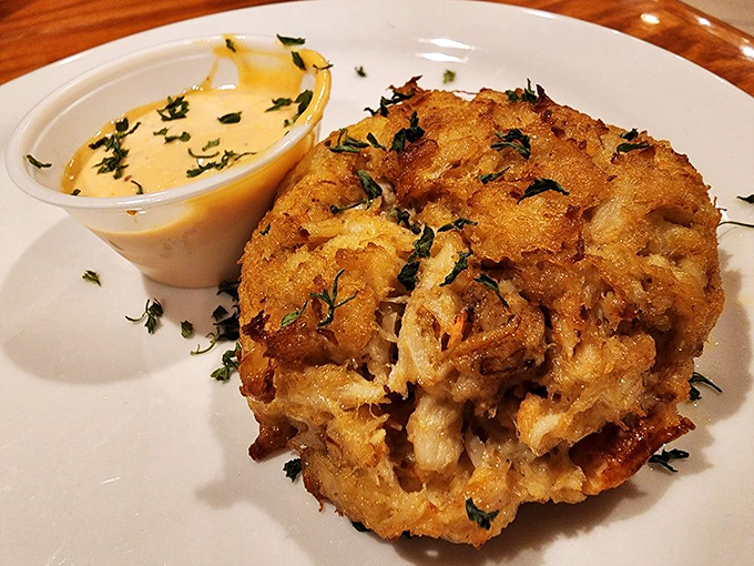 Golden-crusted crab cake that looks like it just won the seafood lottery – and you're the real winner.
