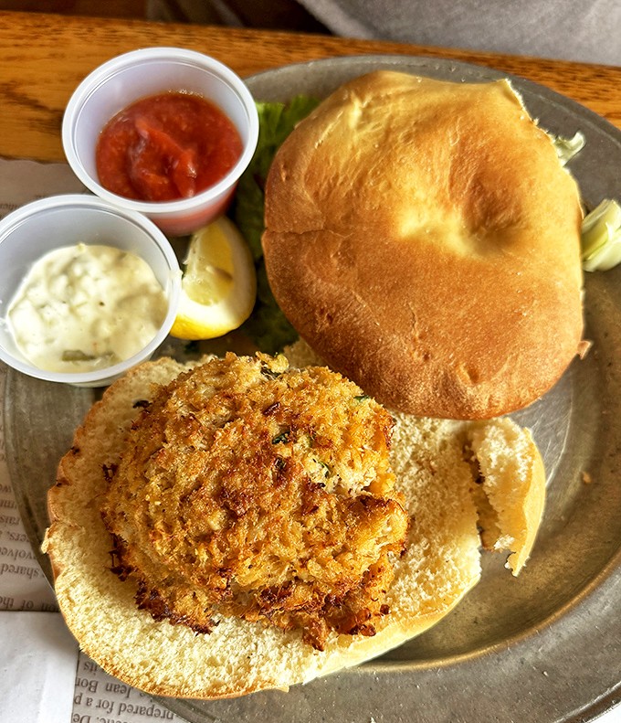 This isn't just a crab cake sandwich&mdash;it's a golden-crusted masterpiece of jumbo lump meat, served with classic accompaniments that let the seafood shine.